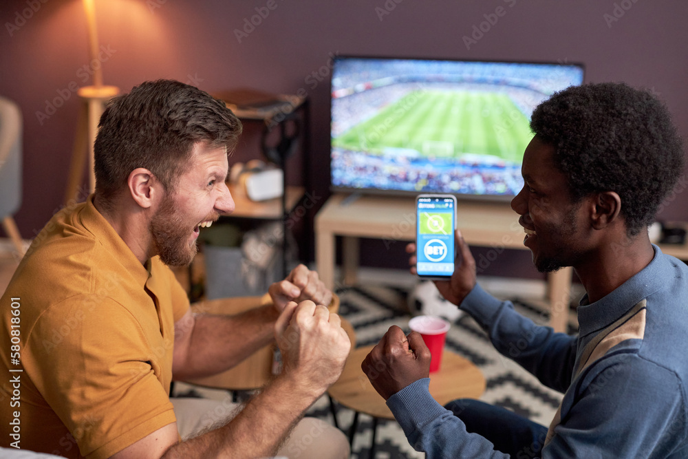 Side view portrait of two emotional football fans watching match at ...