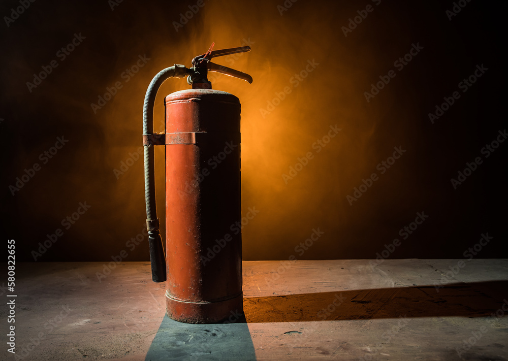 Fire extinguisher on dark background. Fire protection concept. Stock ...