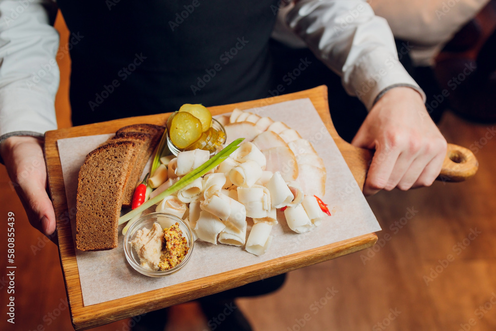 In a beautiful restaurant, a waiter brings a ready-made dish for a ...