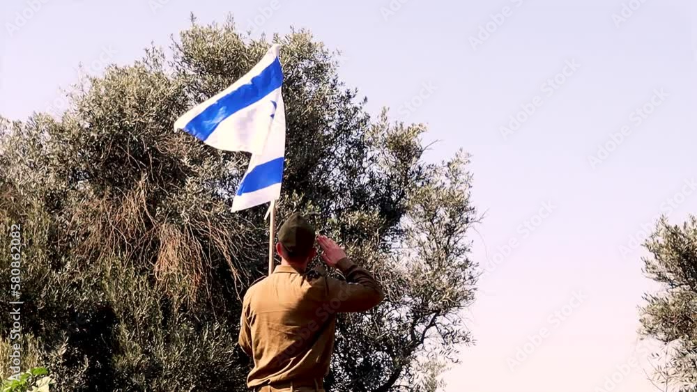 Israeli Army Soldier saluting the Flag of Israel. Themes: Holocaust ...