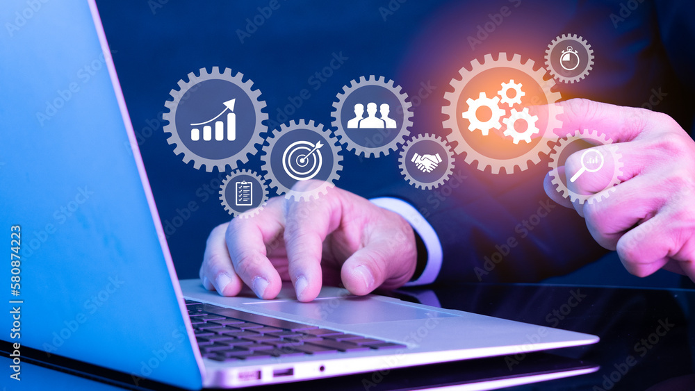 Businessman showing virtual screen of gear cog icon present operation management involving ...