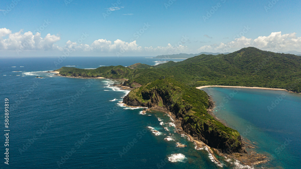 The coast of the island with beaches and rainforest. Cape Engano ...