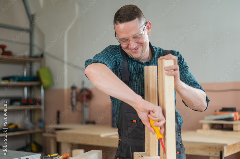 Caucasian man assembling a table with a screwdriver. Stock Photo ...