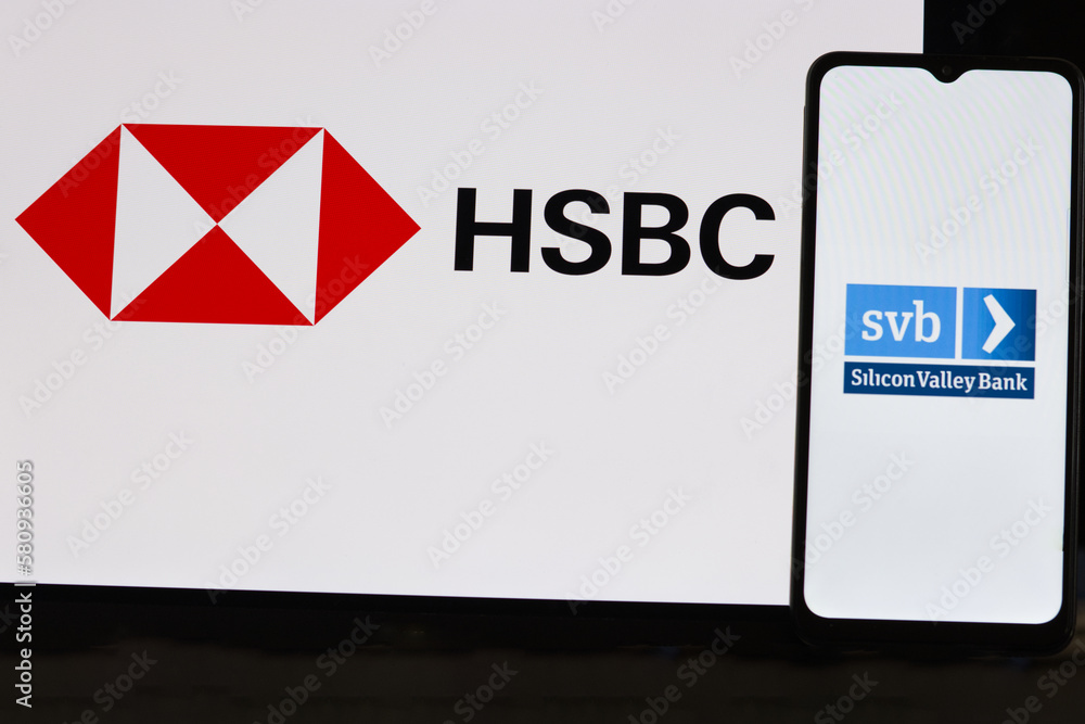 Smartphone with SVB - Silicone Valley Bank logo on background of HSBC bank symbol in the ...