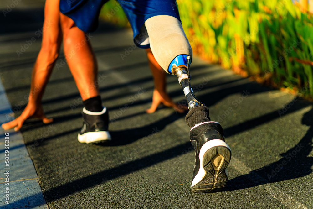 disabled athlete man with prosthetic leg starting to run at the beach ...