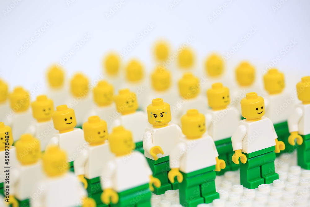 Hong Kong -March 15 2023: minifigure as a man wake up inside the crowd ...