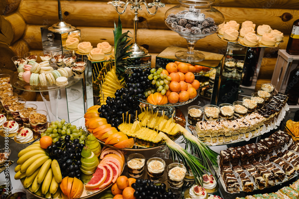 Candy bar. Fresh, exotic fruits, light snacks on a buffet table ...