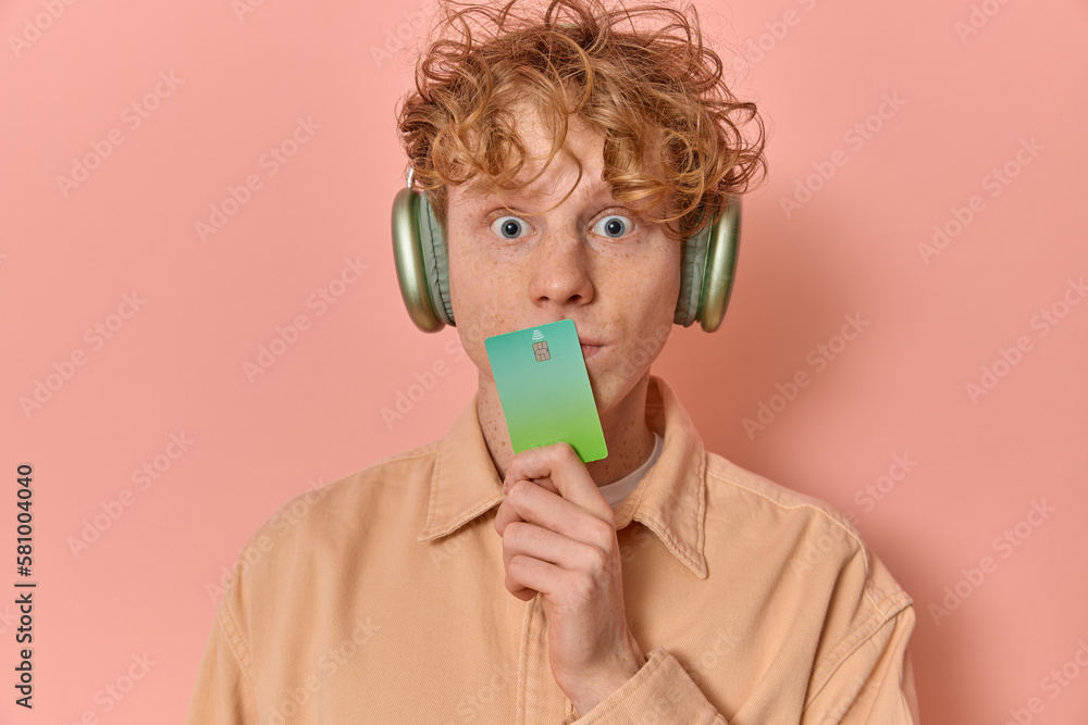 Studio shot of young surprised shocked man gen z with curly red hair ...