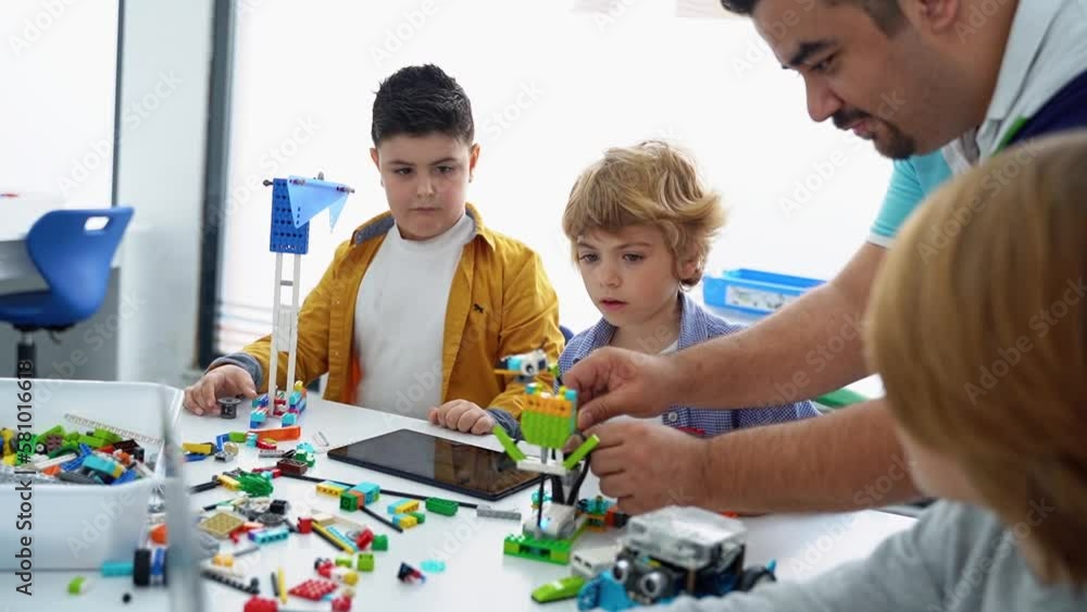 Robotics programming class. Children construct and code Robot. STEM ...