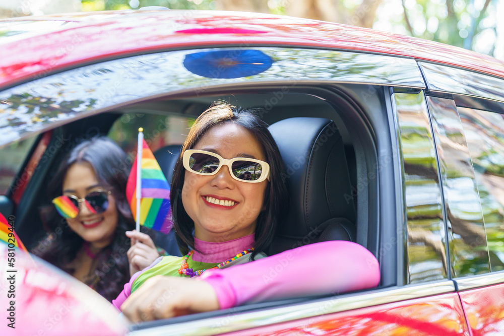 Happy Asian woman support LGBT pride parade in car. with Rainbow of ...