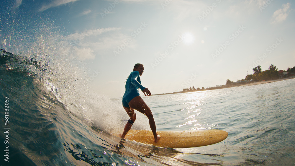 Slim woman surfer rides the wave. Woman surfs the ocean wave in the ...