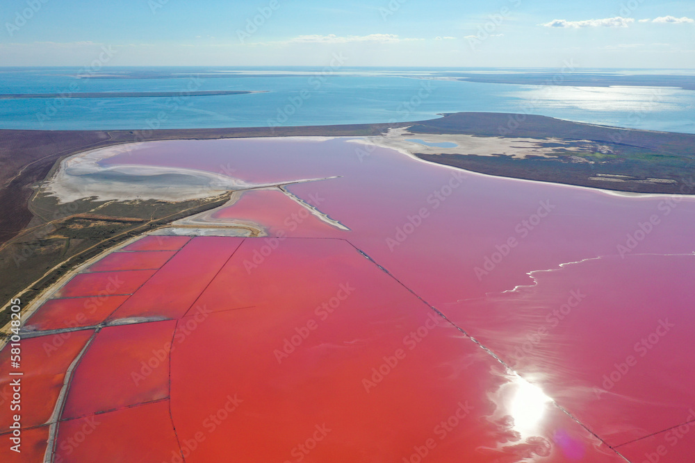 Aerial view of the colorful pink salt lake and the Black sea in Kherson ...