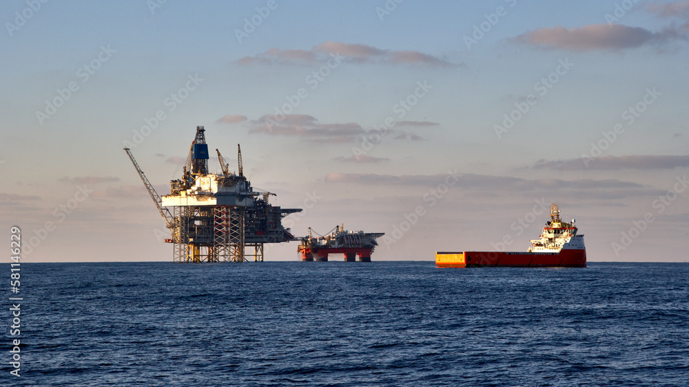 View of jack up drilling rig, platform in the sea with supply vessel in ...