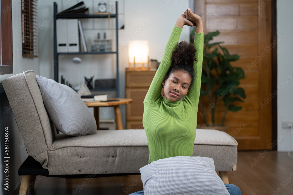 Young calm black woman relaxing in modern living room, lazy happy ...