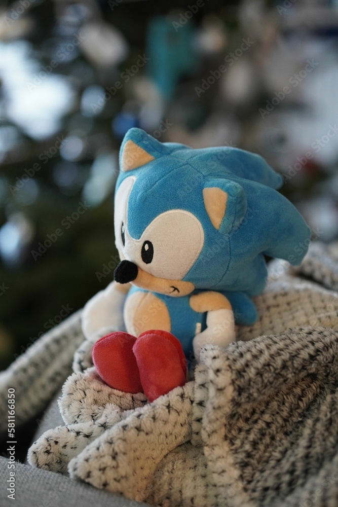Blue Sega brand Sonic The Hedgehog plush toy sitting on a sheet Stock ...