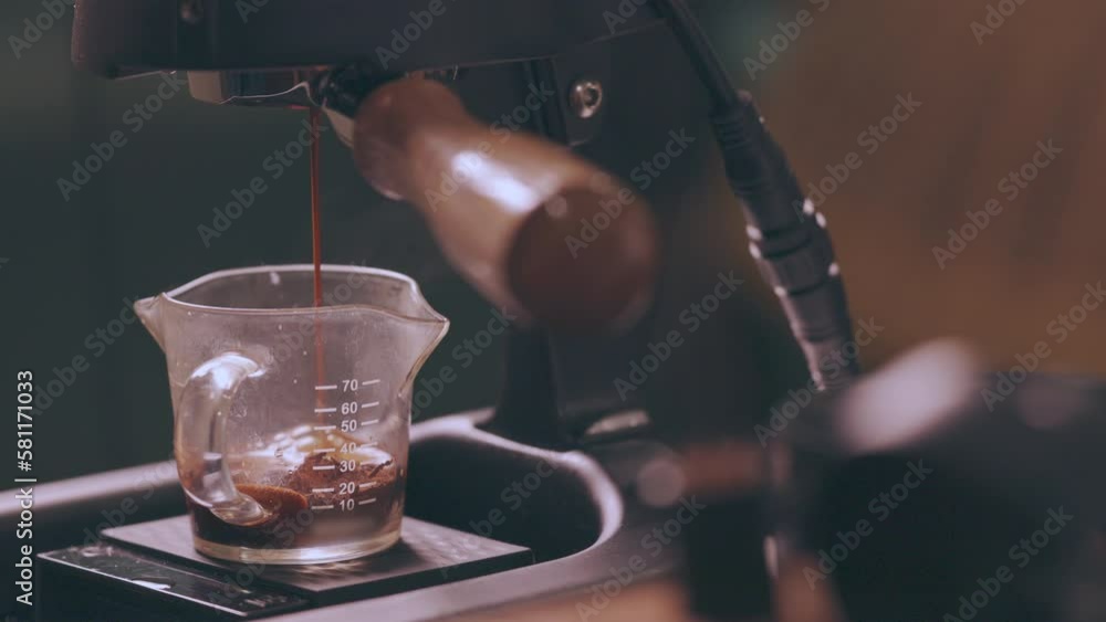 Close up slow motion 4K of beautiful coffee liquid flowing from coffee ...