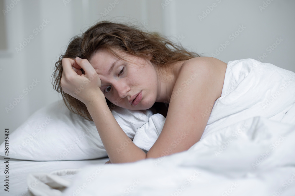 Foto Stock Young sad depressed unhappy worried woman in the bed in ...