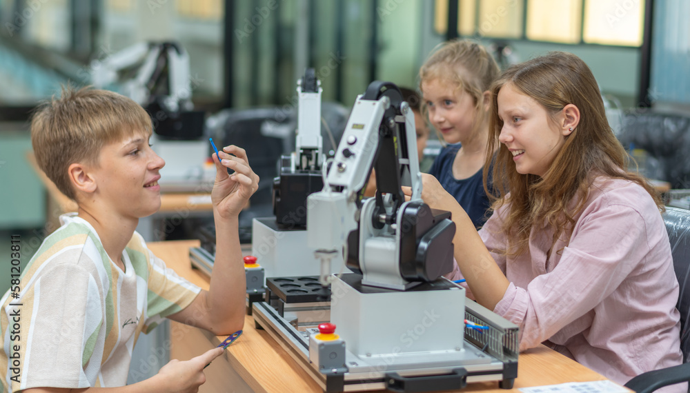 Group Kid teen child enjoy Machine Learning Robot arm is Moving Under ...
