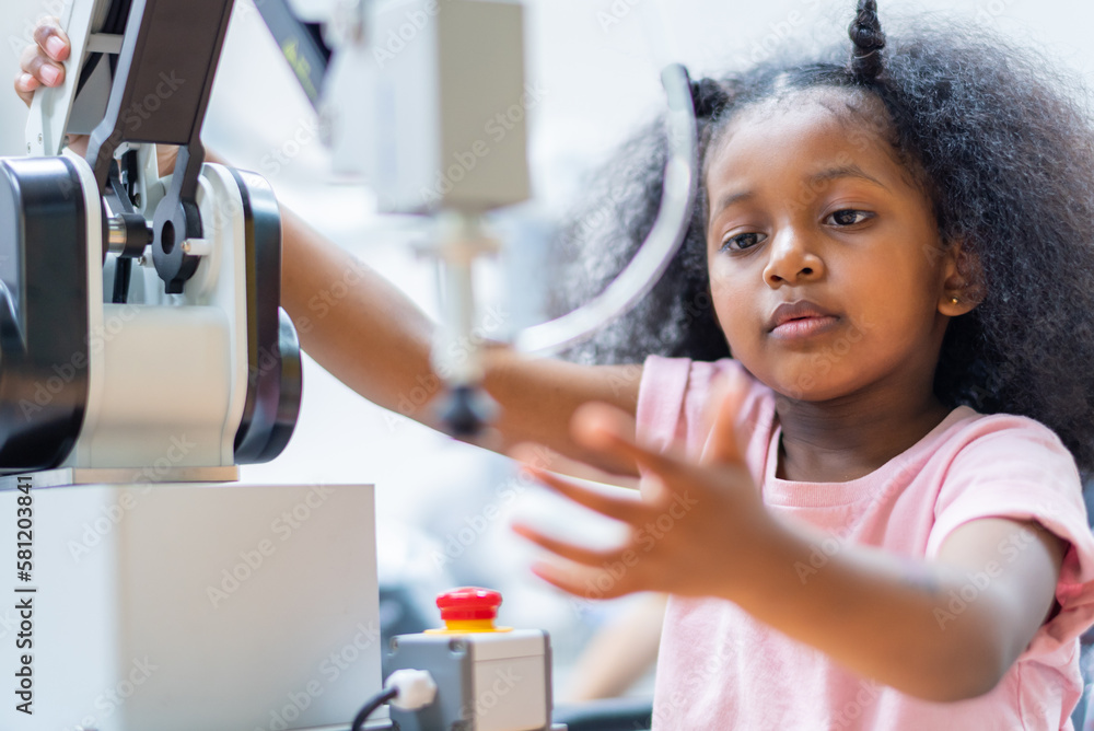 Kid female teen child enjoy Machine Learning Robot arm is Moving Under Control robot at ...
