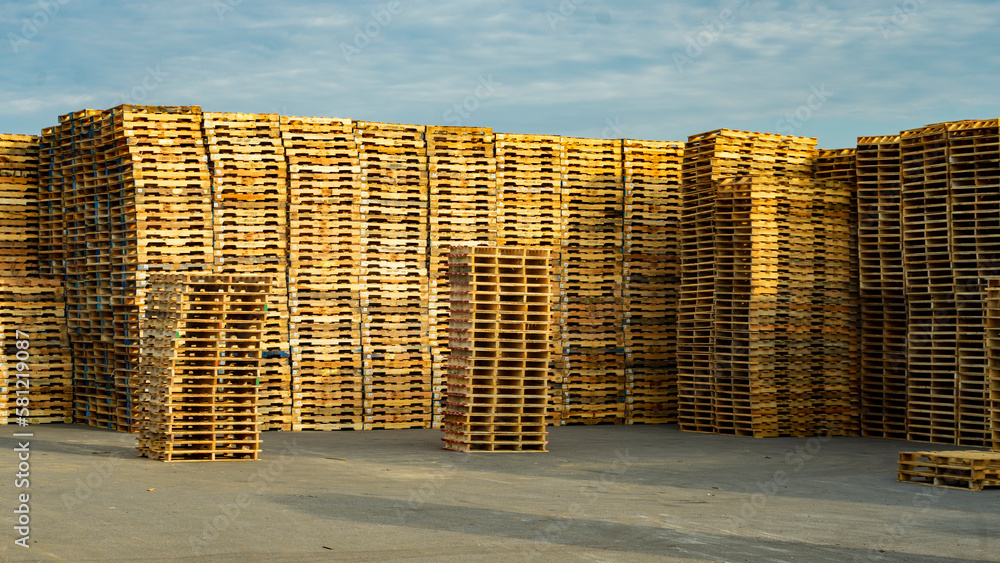 Stack of wooden pallets in industrial pallet yard - logistics pallet ...