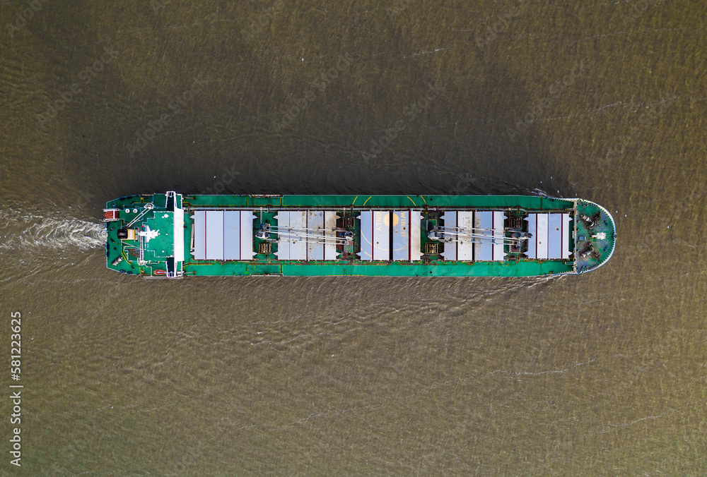 Aerial view of container ship and shipping containers in bay waters ...