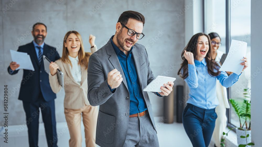Shot of office staff celebrating a win. Success and team work concept ...