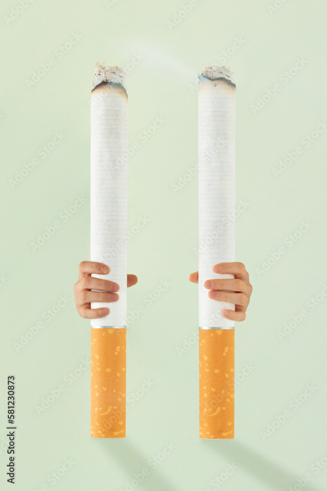 Male hands hold cigarettes made prison bars on isolated pastel green ...