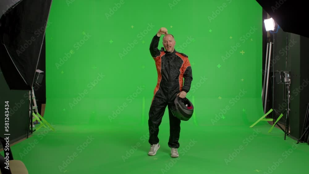 racing driver taking off helmet and celebrating a victory while ...