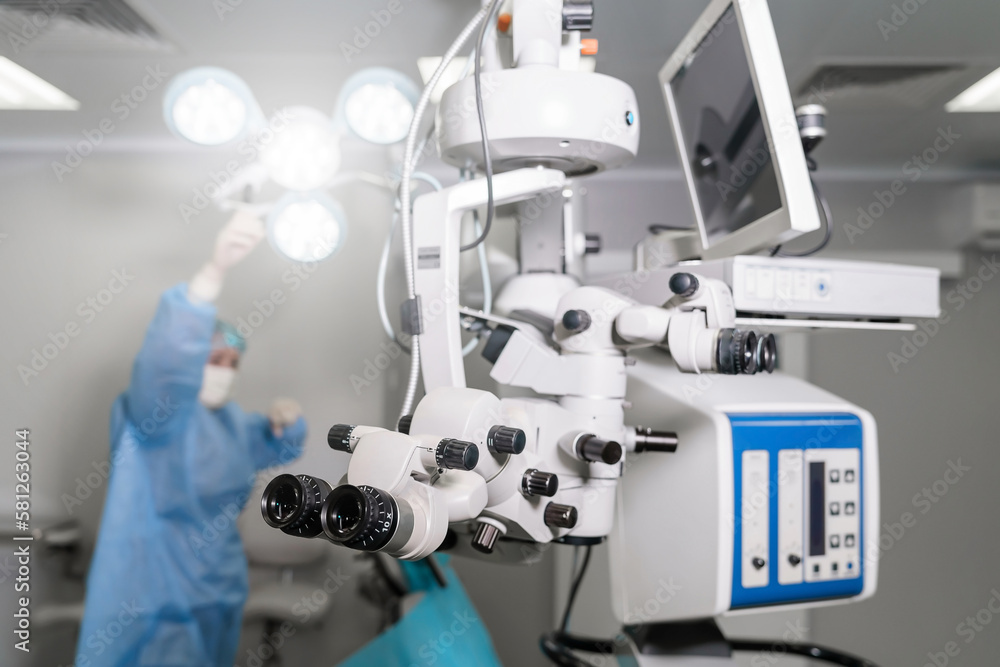 Surgical microscope in operating room with doctors. Ophthalmological ...
