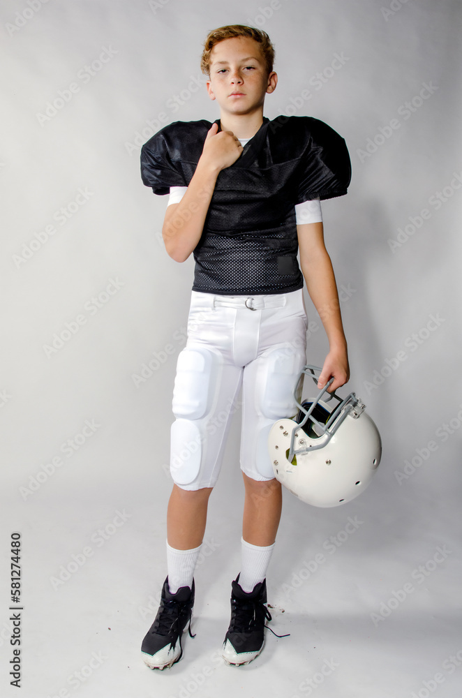 Young Preteen Boy Football Player Standing Holding Helmet in Studio ...
