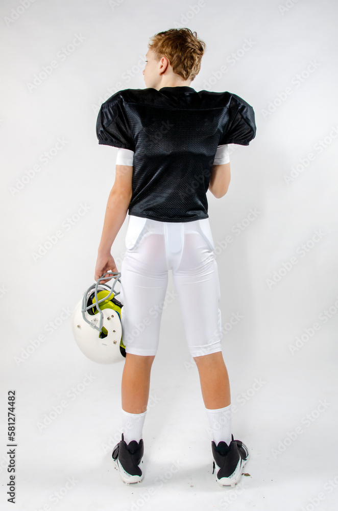 Young Preteen Boy Football Player Standing Holding Helmet in Studio ...