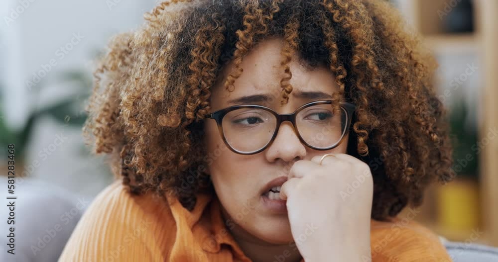 Video Stock Anxiety, worry and nail biting by black woman on a sofa ...