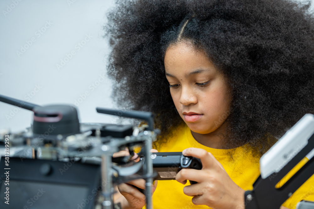 Girl female teen children concentrate enjoy Machine Learning Robot is ...