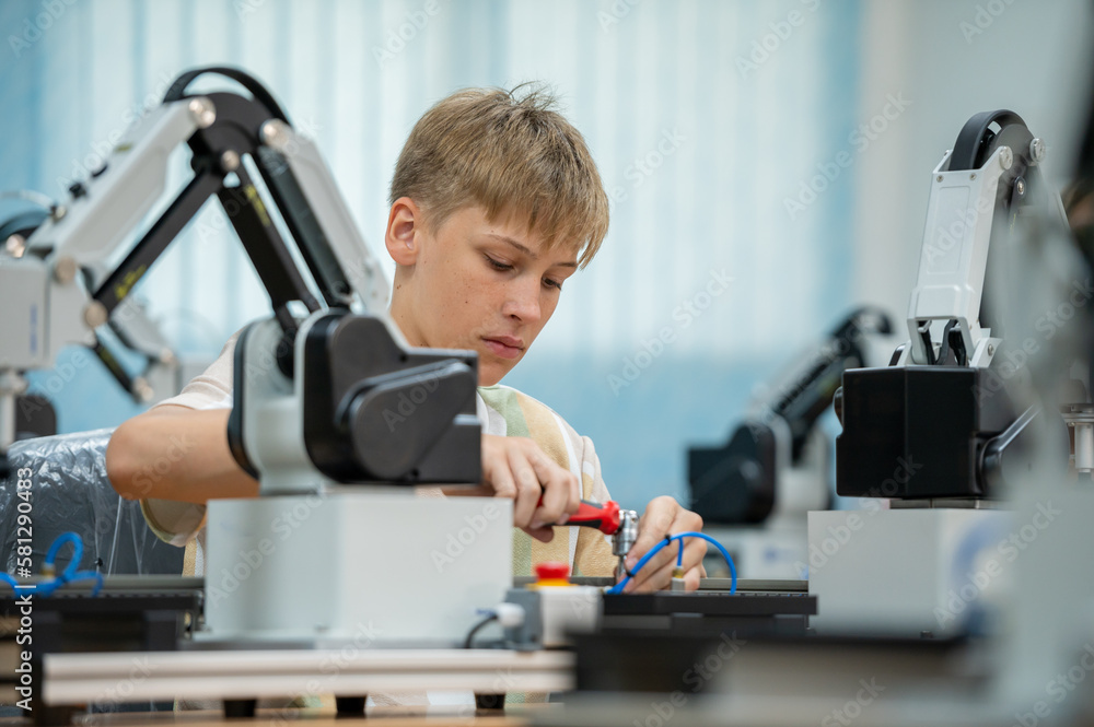 Boy male teen child concentrate enjoy Machine Learning Robot is Moving ...