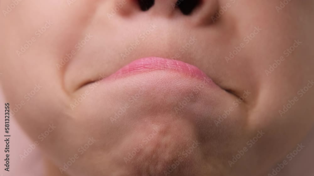 Cute little girl compress one's lips close. Close-up portrait of ...