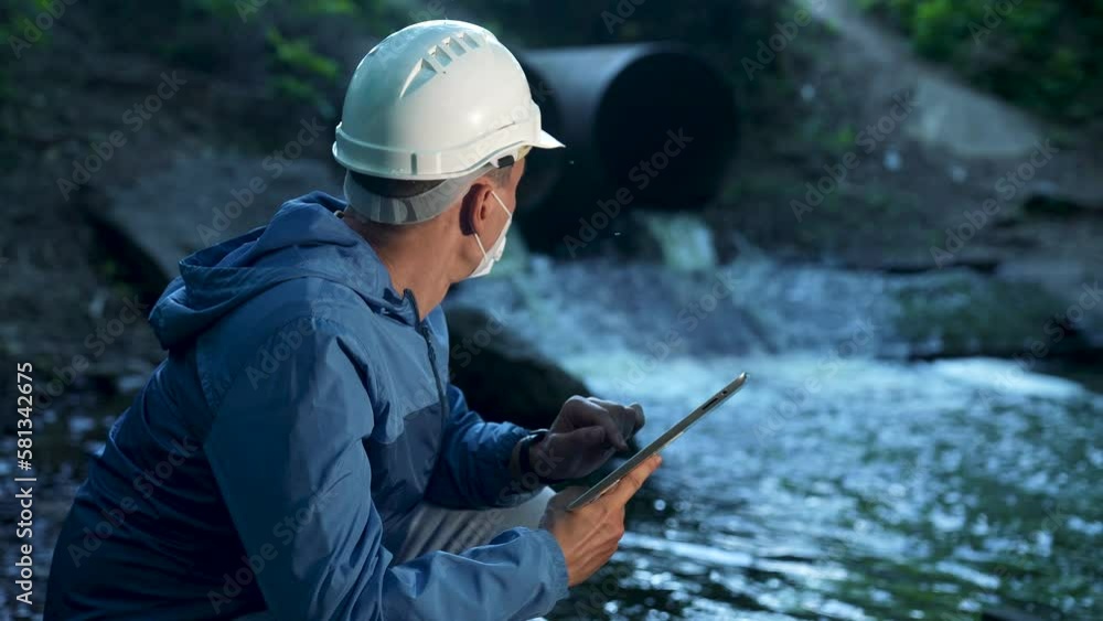 Engineer worker checking water quality of river. Wastewater treatment ...