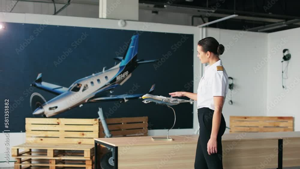 Side view of woman wearing uniform working as pilot instructor. Female ...