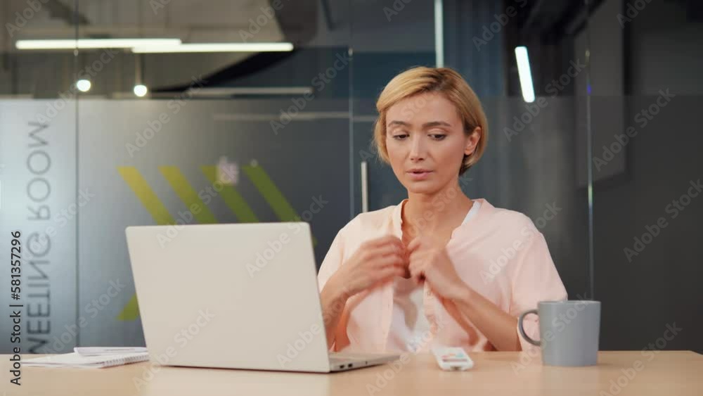Video „Overheated woman at workplace feeling upset, waving hands to ...