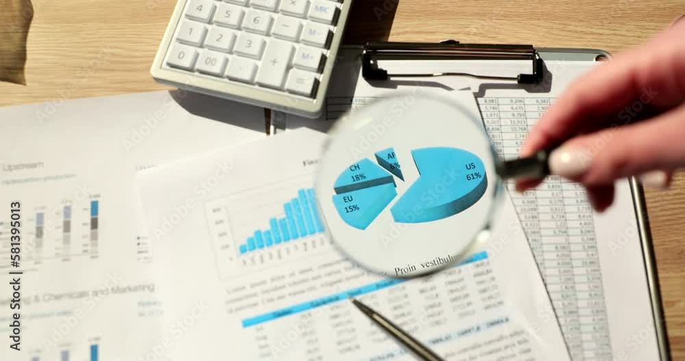 Magnifying glass focusing on chart and financial report in charts Stock ...