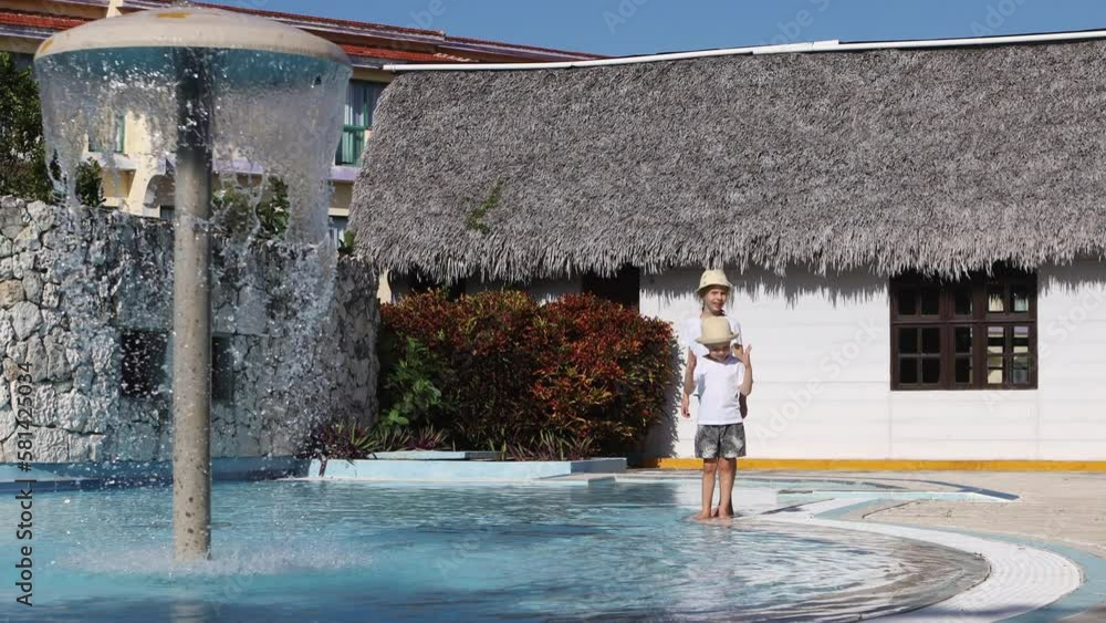 A boy and a girl came for the summer holidays.Children play by the pool ...