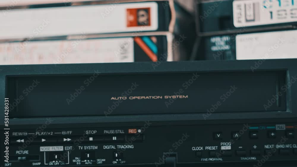 Male hand pulls out VHS from a vintage videotape recorder. Eject VHS ...