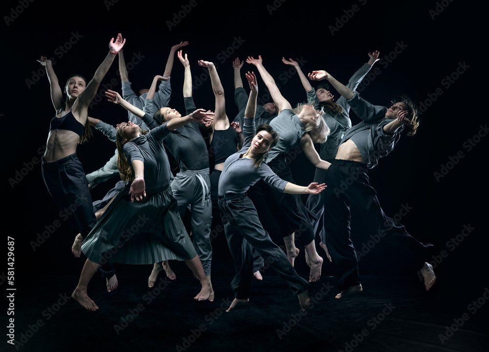 Group of young people in gray stage costumes making performance ...