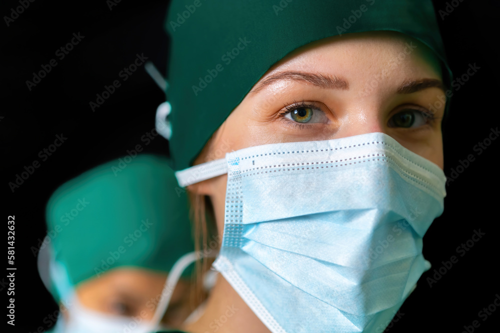 nurse help surgeon wearing medical uniform to protect body in operation ...