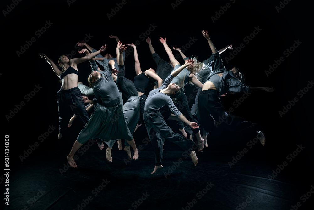 Flying high. Group of young artistic people making freestyle ...