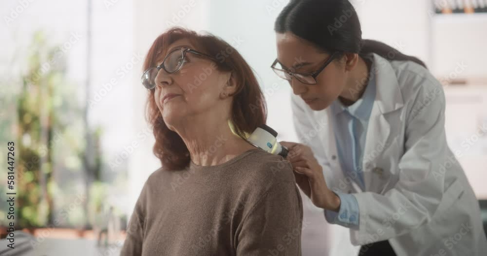 Portrait of a Young Asian Dermatologist Using a Medical Magnifying ...