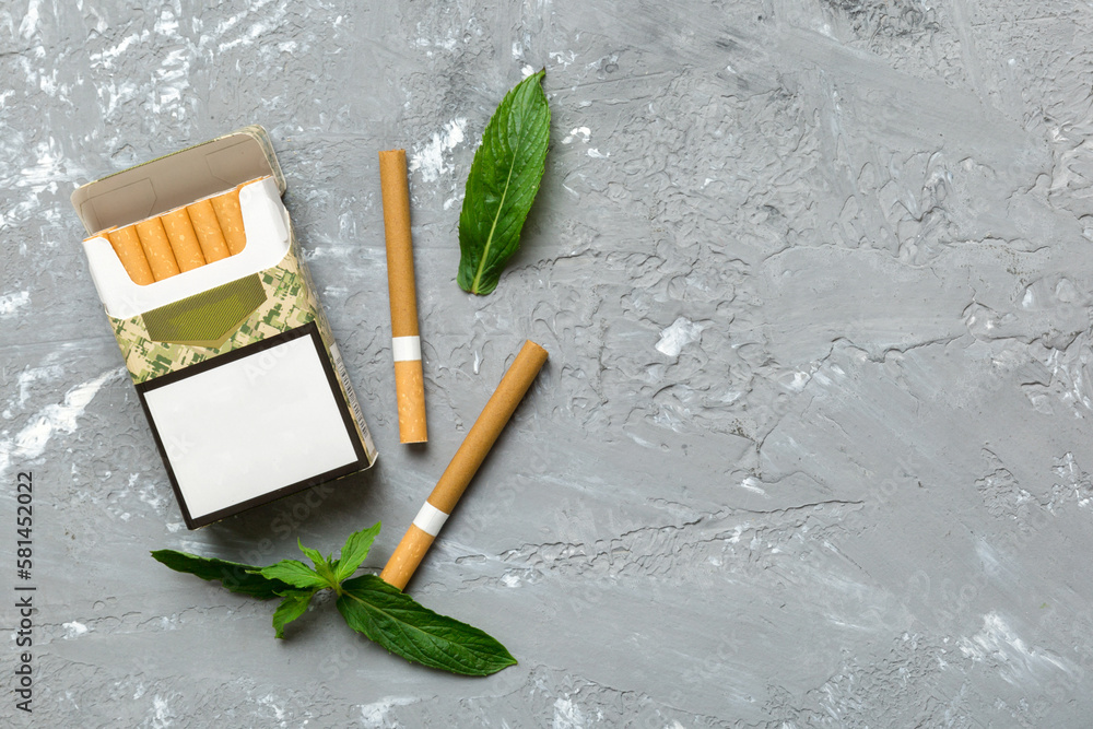 Pack of menthol cigarettes and fresh mint on colored table, Menthol ...
