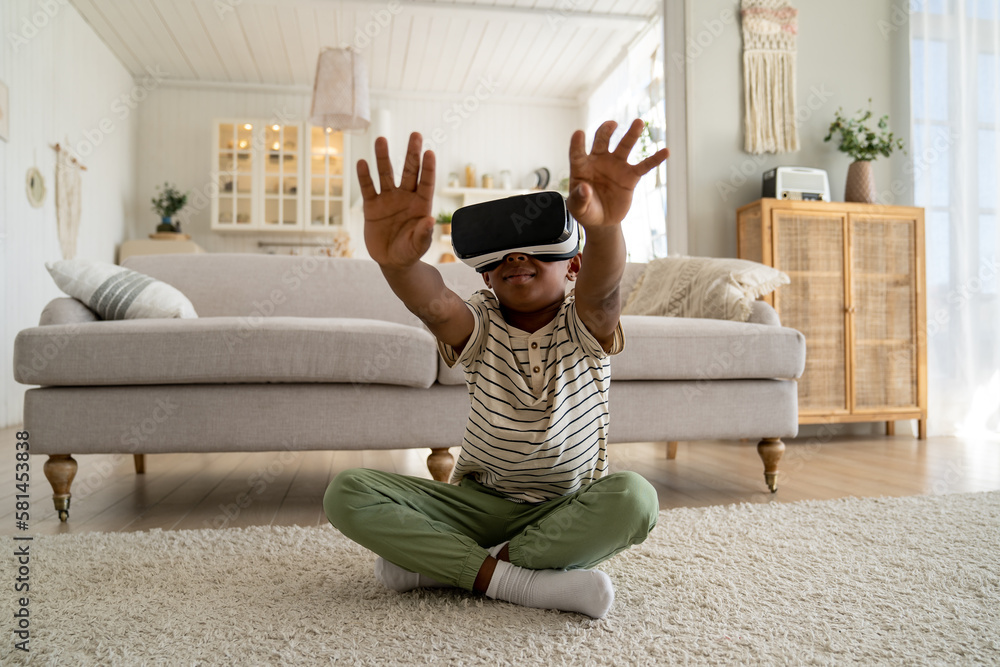 New technologies and children. Happy African American kid boy in ...