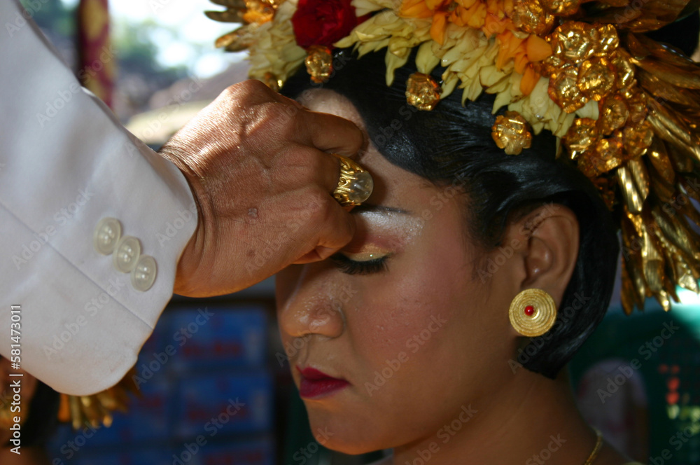 Hand Priest giving sign with rice on forehead a Woman after ceremony of ...