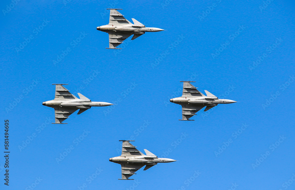 Formation of four military fighters flying in unison at the air show ...