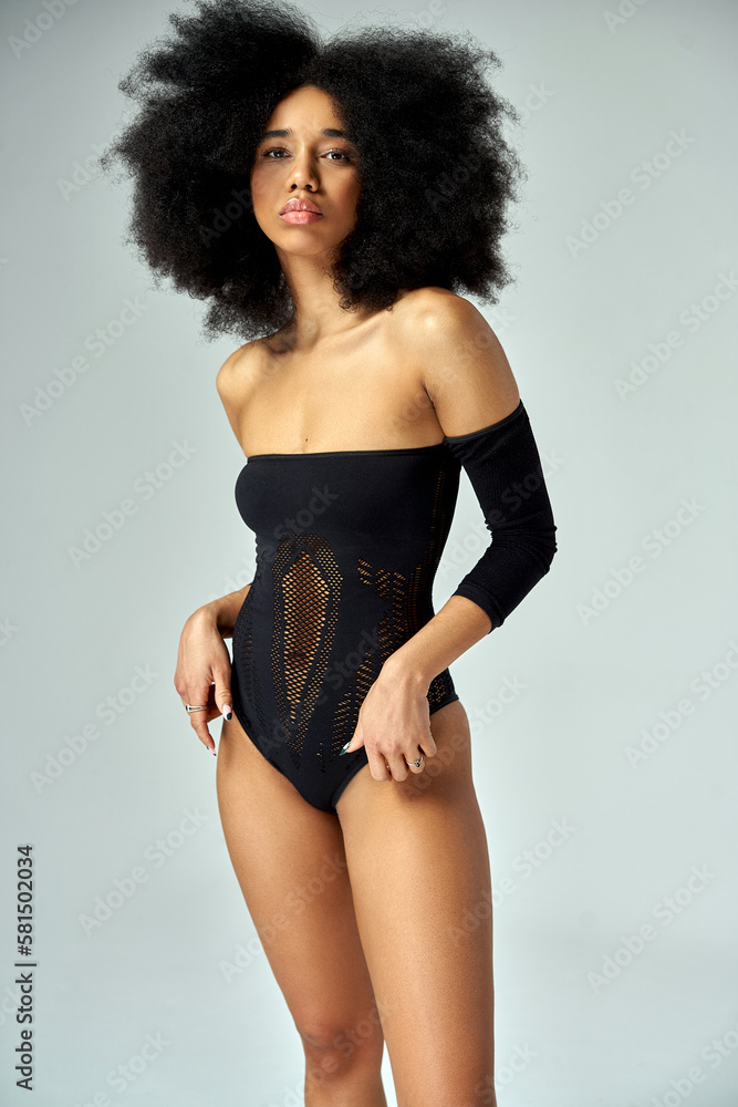Sexy african american girl with an afro hairstyle wear black bodysuit Stock Photo | Adobe Stock